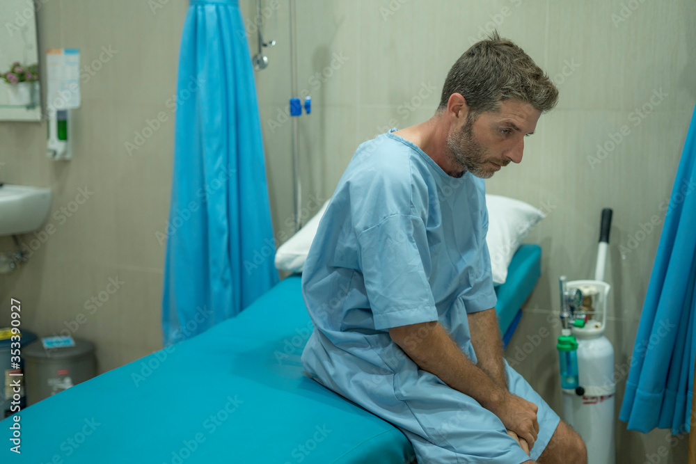 scared and worried man hospitalized - attractive injured man sitting on ...