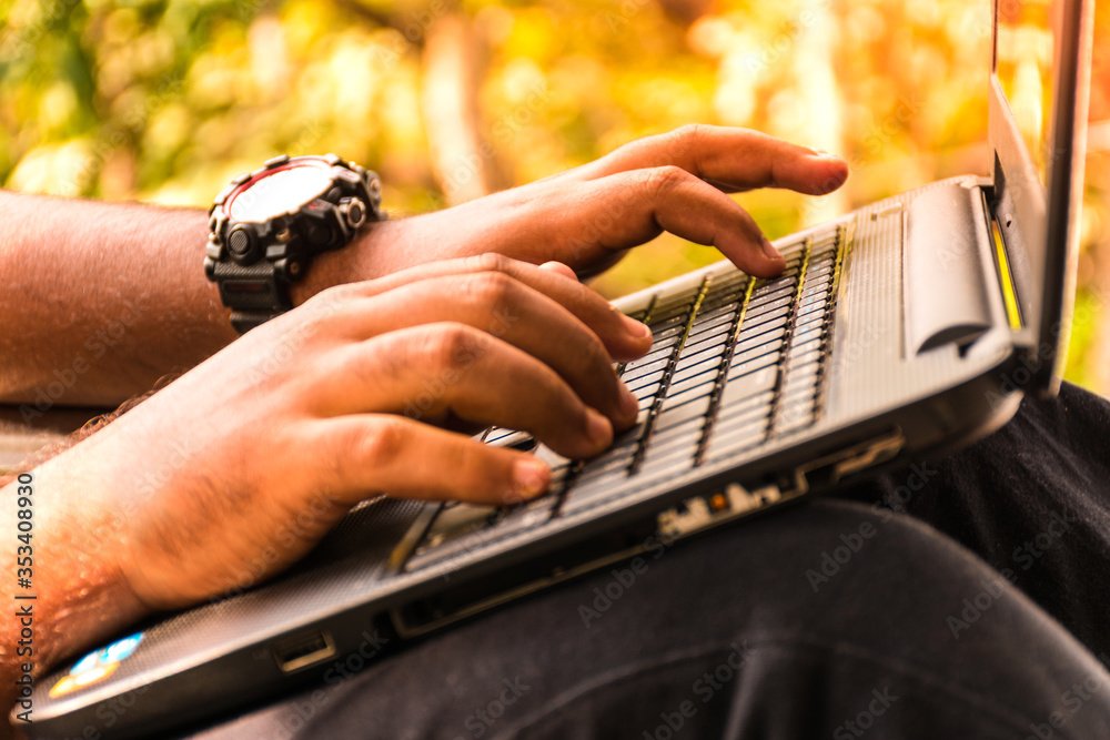 Typing on Laptop Keyboard with yellow green blur background Stock-Foto ...