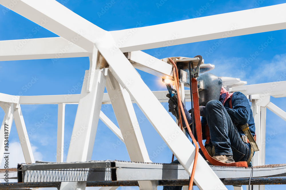 Industrial welder welding fabricated metal truss structure assembly on ...