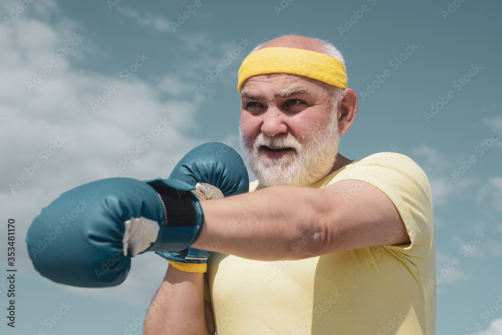 Best cardio workout. Elderly man hitting punching bag. Healthy fighter ...