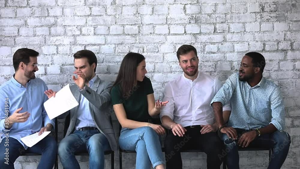 Happy young energetic diverse unemployed people sitting in row line on ...