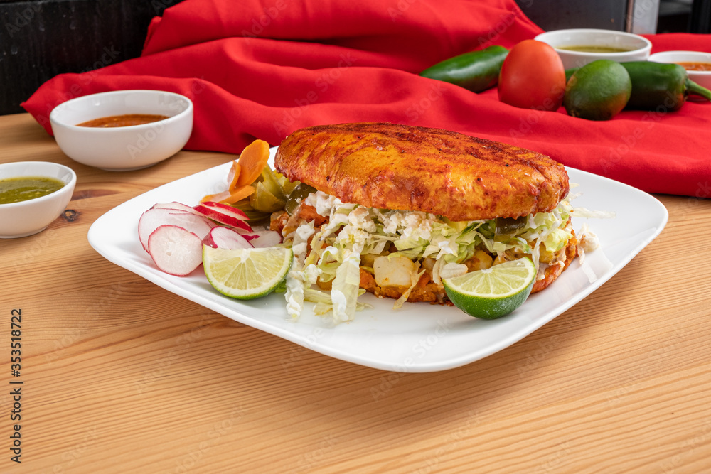 Mexican sandwich known as a torta. Fresh bread roll with grilled meats ...