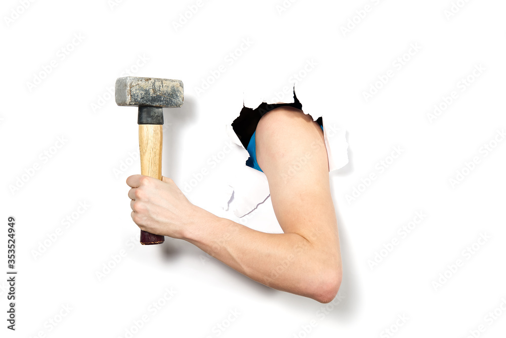 close-up hand with hammer through a torn white paper, isolated. hand ...