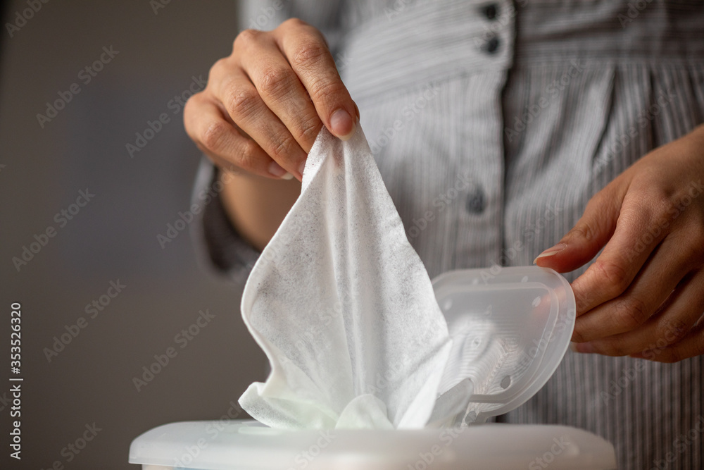 Wet wipes are universal an practical: woman take one wipe from big ...