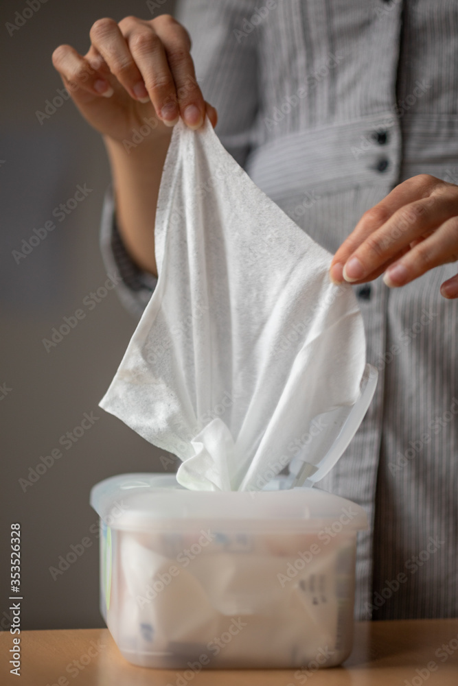 Wet wipes are universal an practical: woman take one wipe from big ...