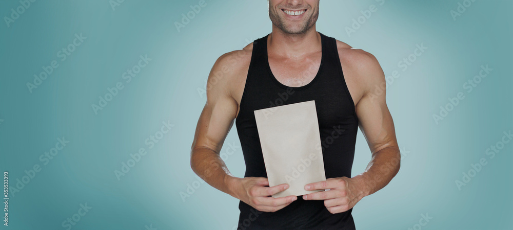 muscle man holding black paper on gym Stock Photo | Adobe Stock