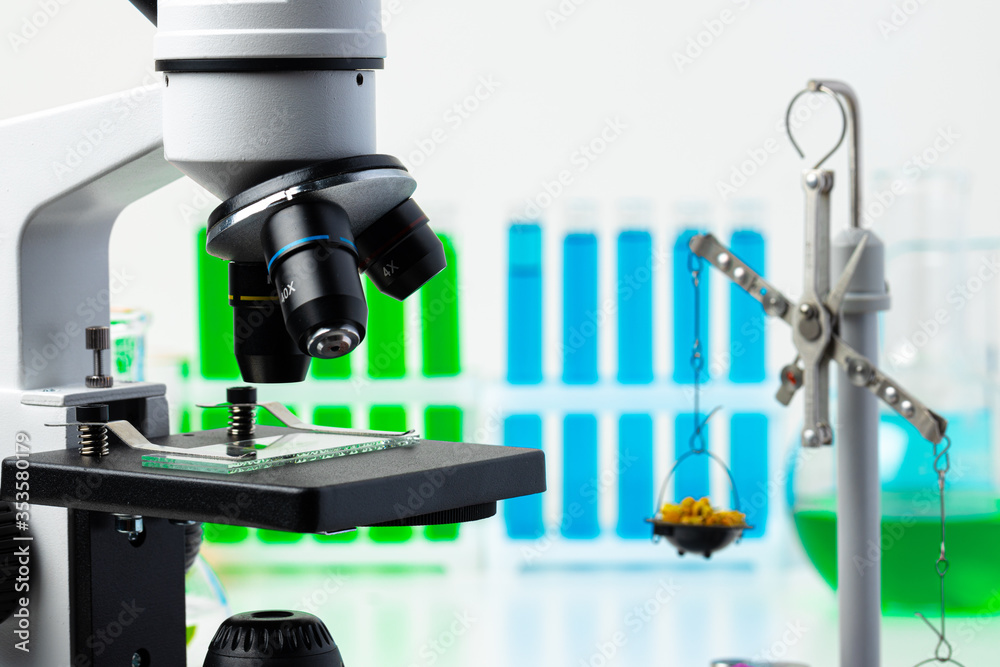 Medical laboratory. Scientific microscope with test tubes and plants ...