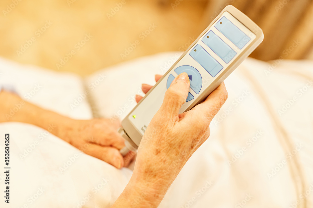 Hands of a senior citizen hold remote control Stock Photo | Adobe Stock