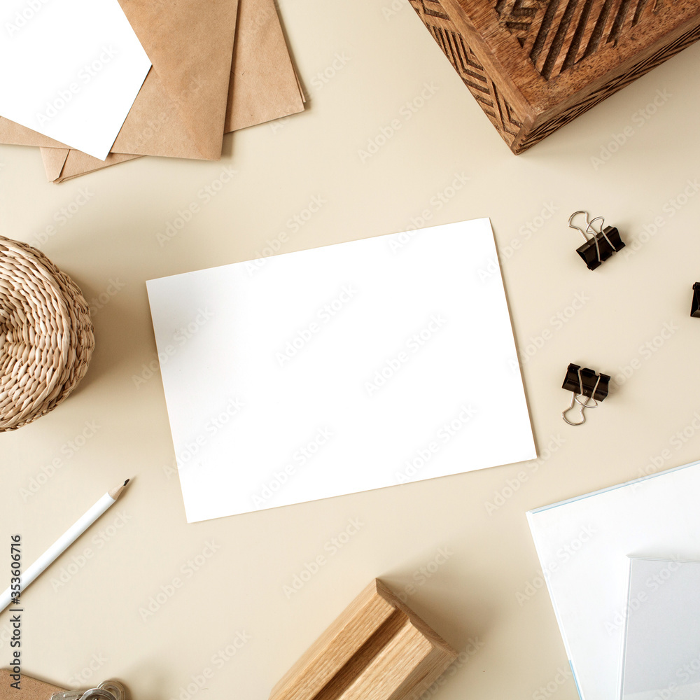 Blank paper sheet on beige table. Artist home office desk workspace ...