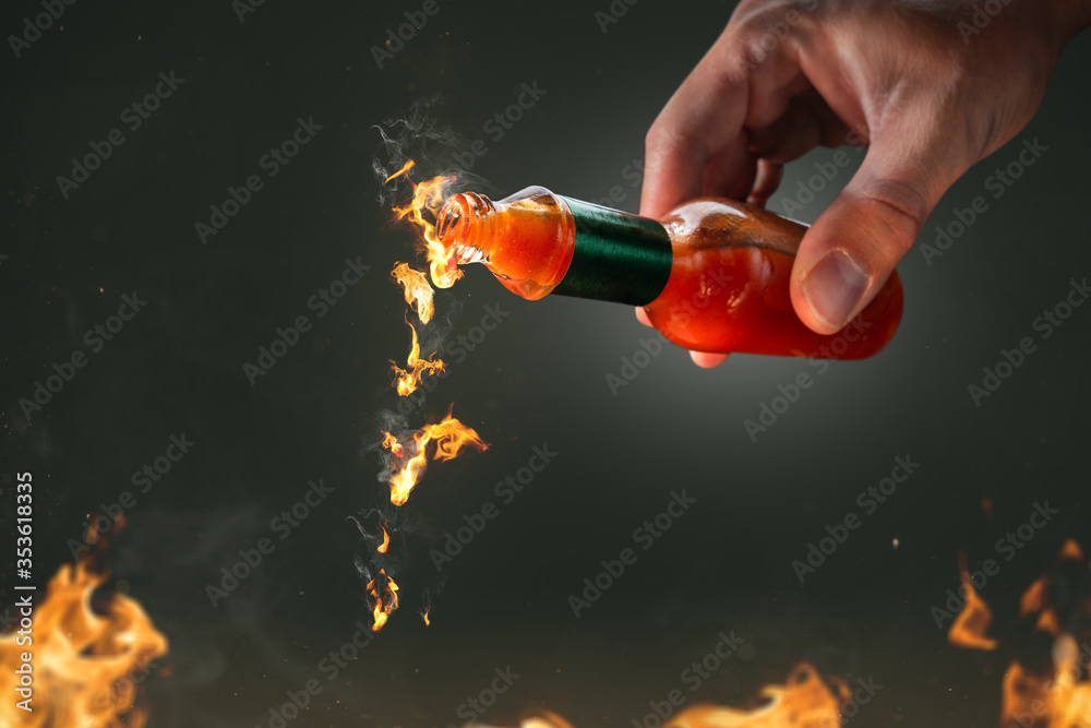 Burning chili sauce pouring out of a bottle Stock Photo | Adobe Stock
