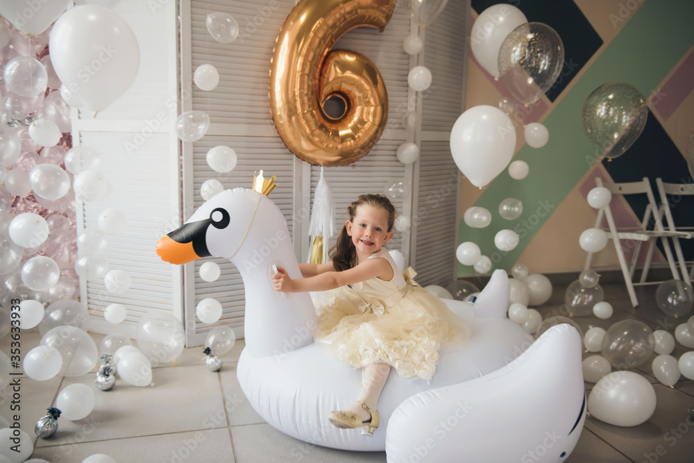 Birthday photo zone with white balloons and inflatable giant white swan ...