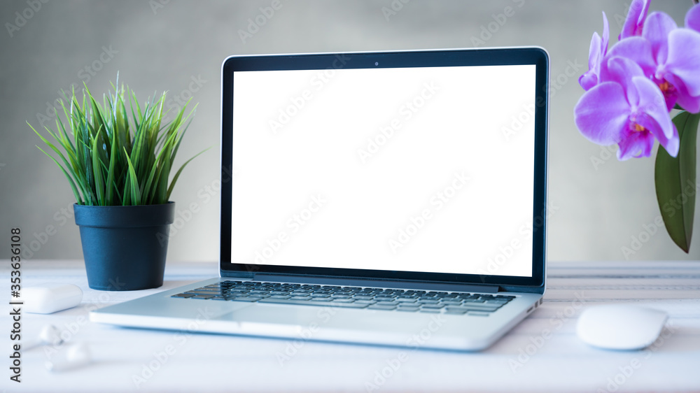 Laptop computer white blank screen on work table front view. Copy space ...