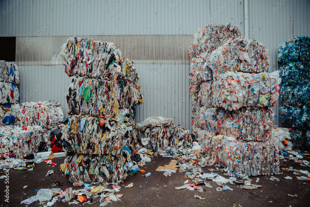 large stacks with compactly packed plastic waste ready for transport ...