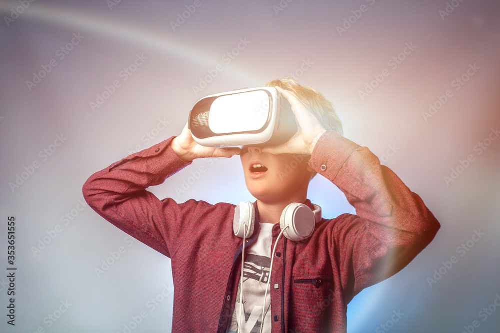boy wearing virtual reality glasses. boy uses a futuristic processor ...