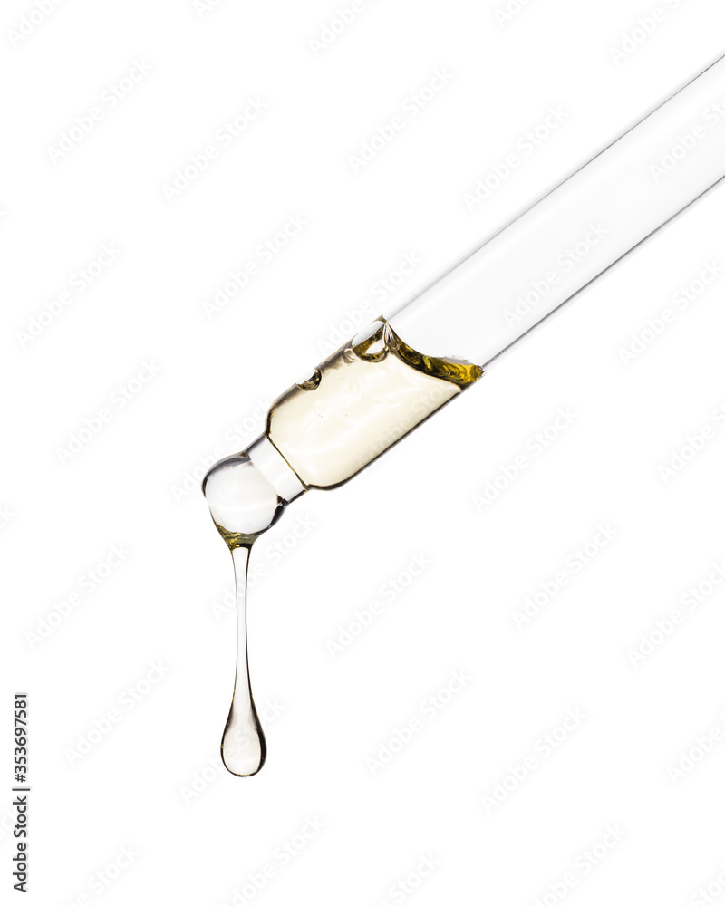 Cosmetic dropper with yellow oil. Glass dropper isolated on a white ...