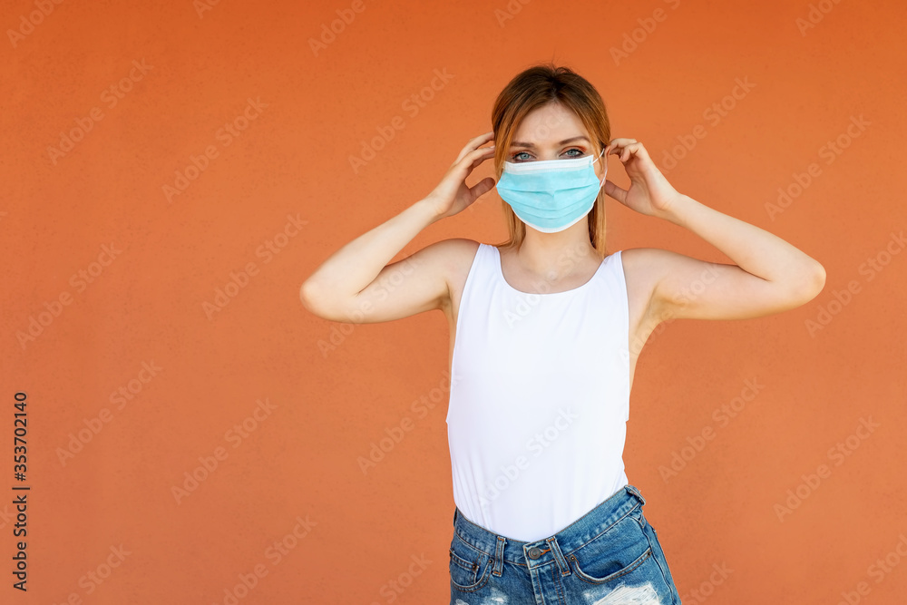 Girl wears a protective mask, uniform colored background. Young girl ...