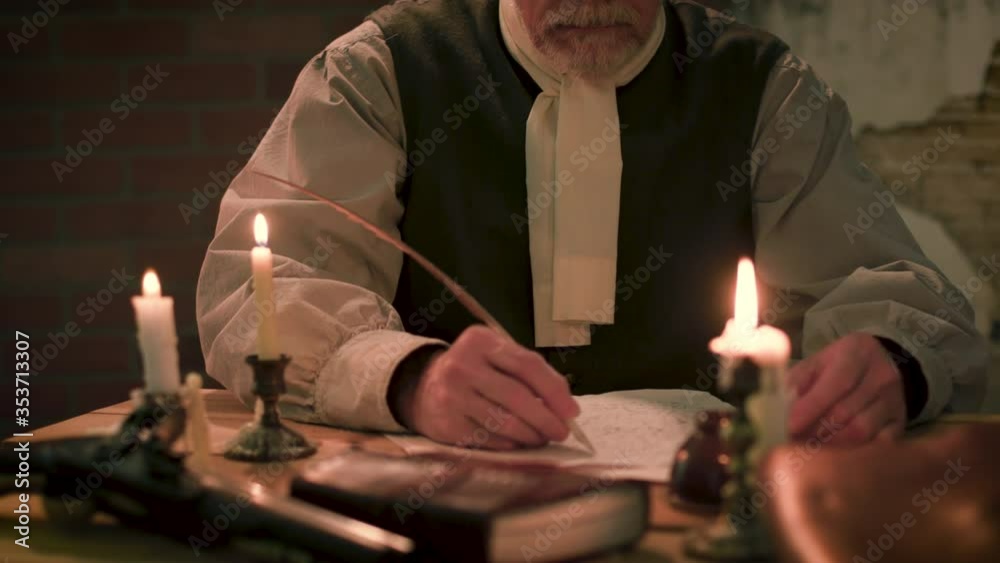 Candle lit scene tilts up from a desk with a flintlock pistol laying on ...