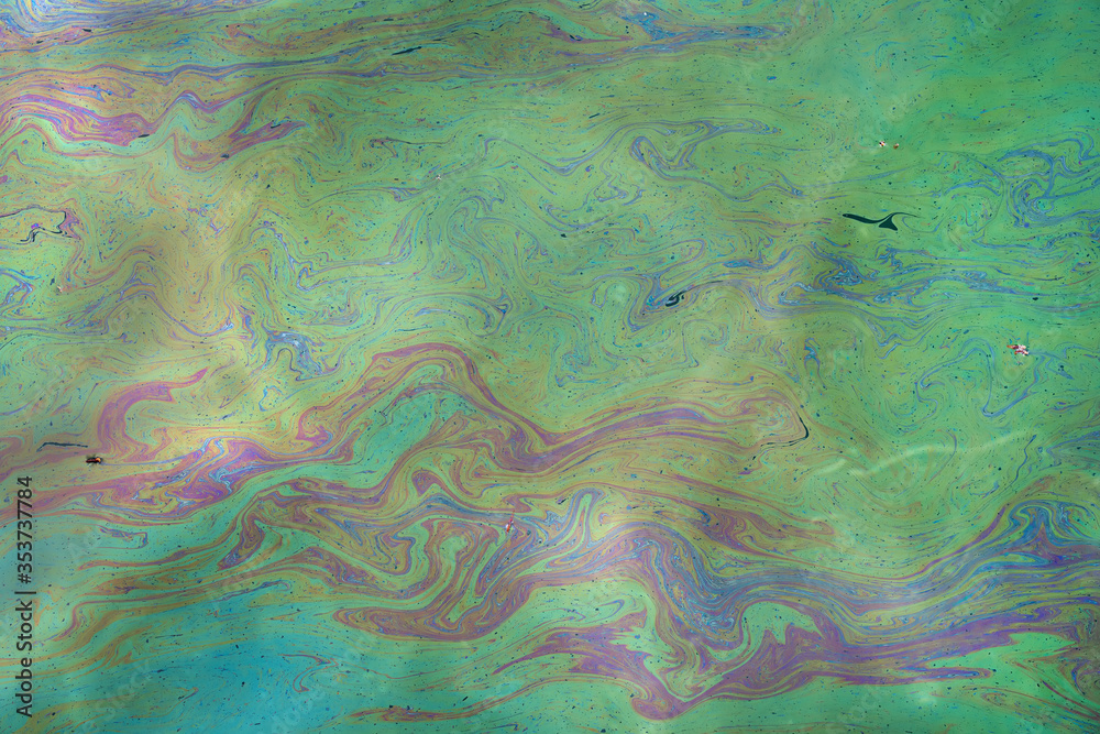 Toxic colours of oil and water in a chemical spill creating a ...