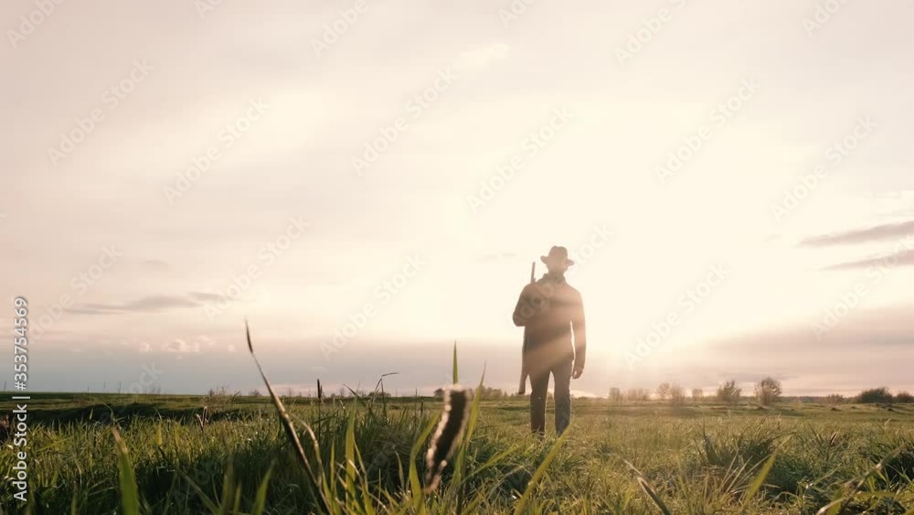 Vidéo Stock Vintage hunter walks. Rifle Hunter Silhouetted in Beautiful ...