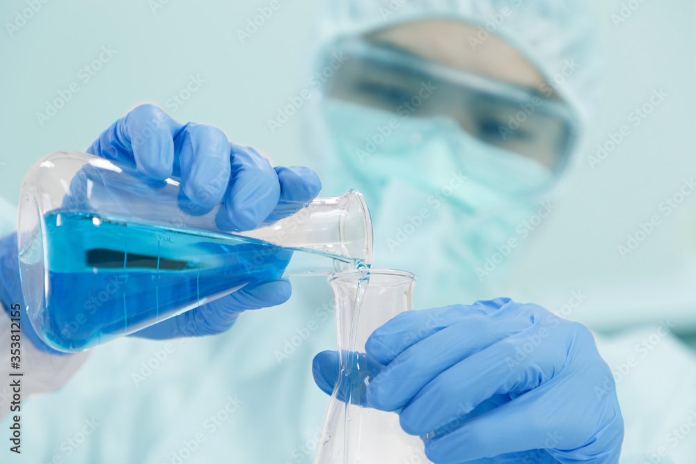 Male Scientist in PPE Suit working in Lab while Pouring Solution from ...