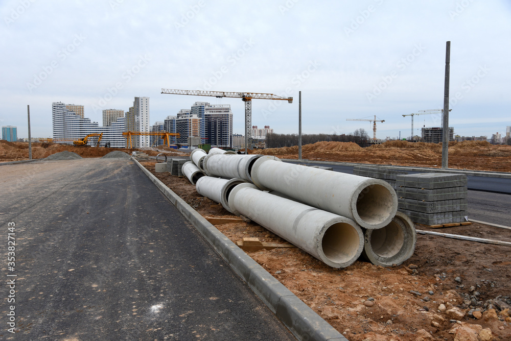 Concrete drainage pipes at the construction site. Laying of underground ...