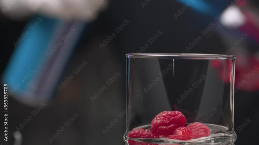 Cooking Raspberry Sambuca. Close up barmans hand sets fire to sambuca ...