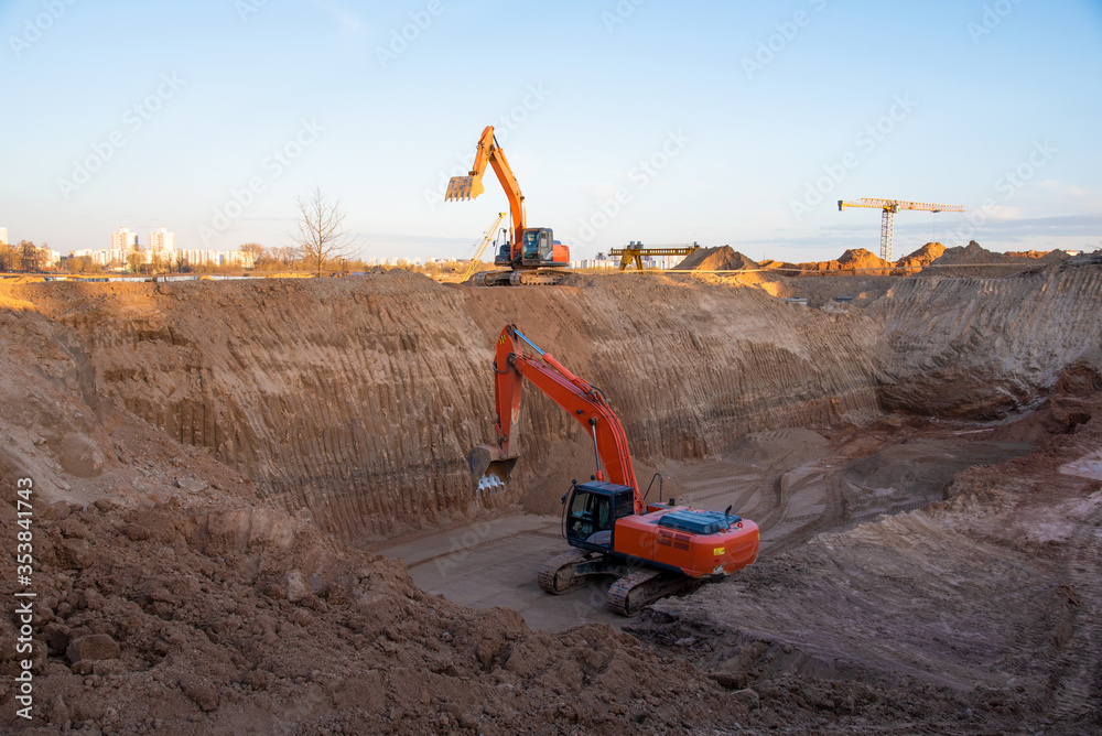 Foto de Digging the pit foundation a hole with excavator. Earthwork in ...