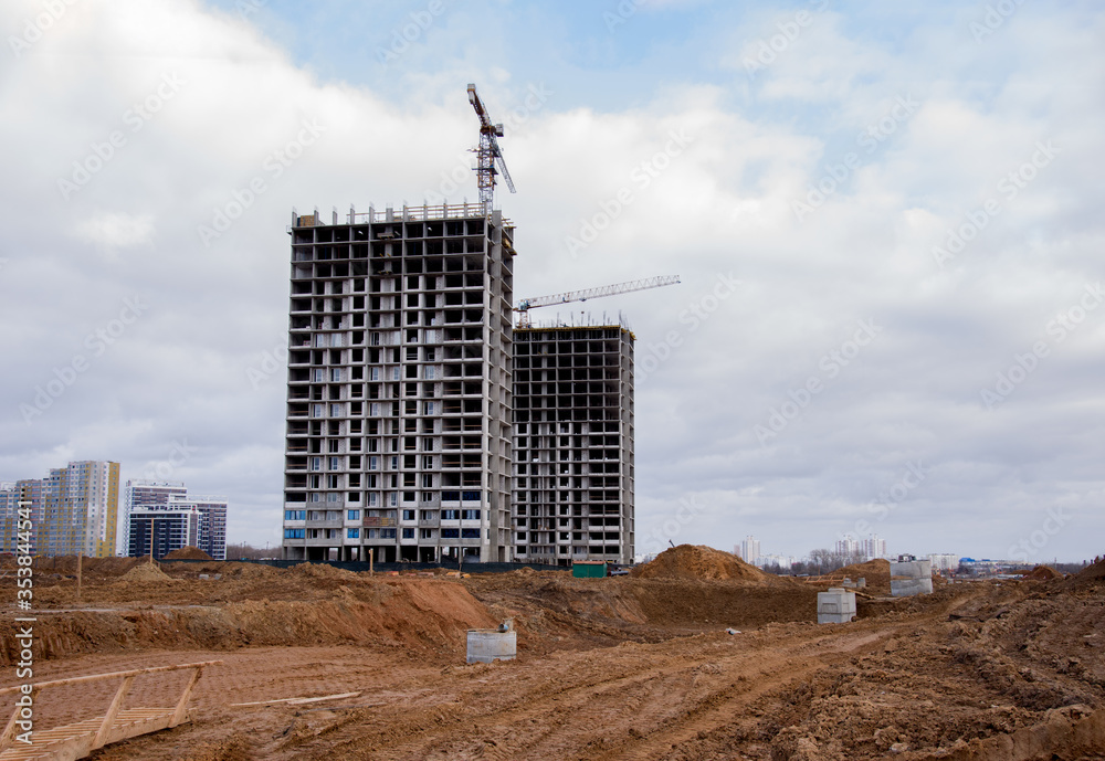 Tower cranes constructing new residential buildings at construction ...