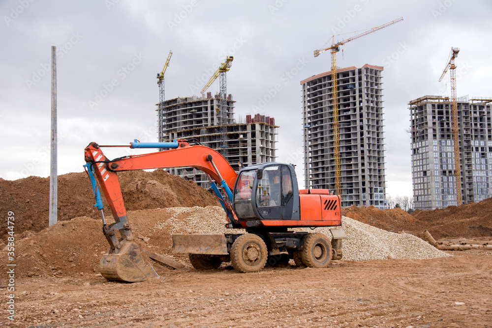 Bucked wheel excavator digs ground at a construction site for ...