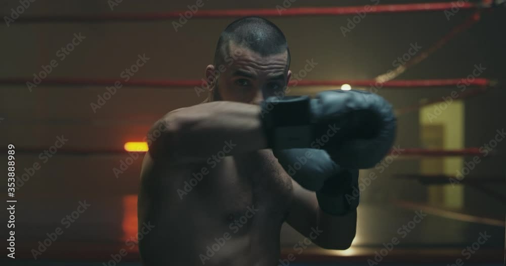 Caucasian shirtless sweaty strong male boxer in gloves standing in ...
