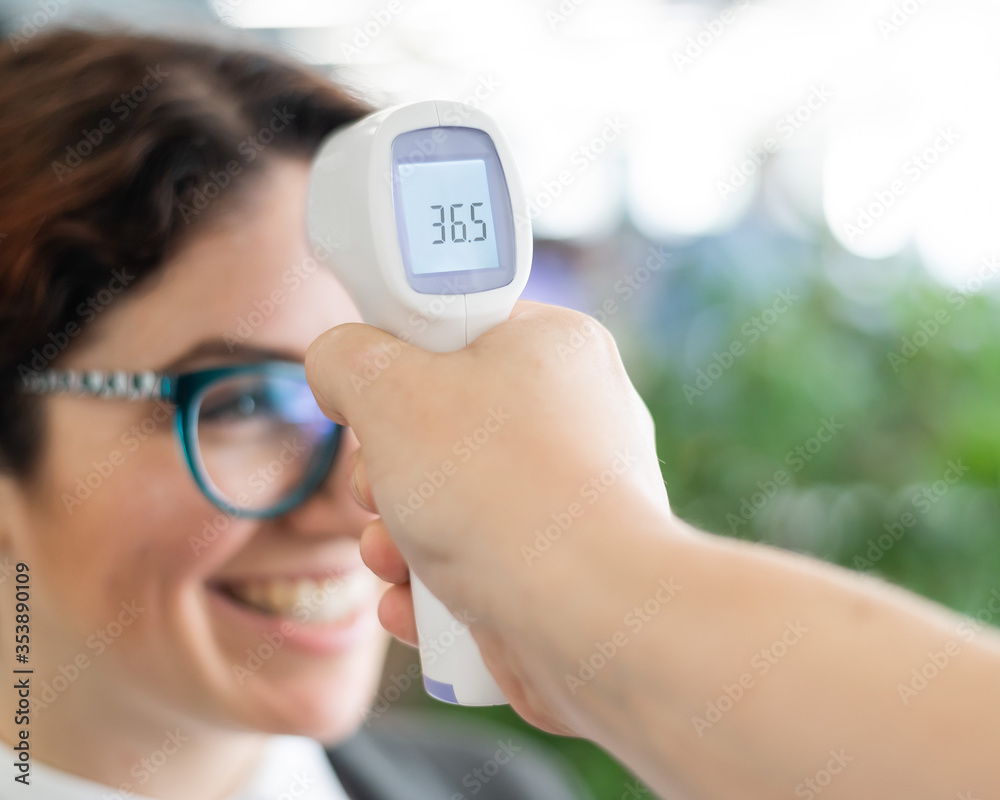 Mandatory measurement of a fever non-contact thermometer gun of all ...