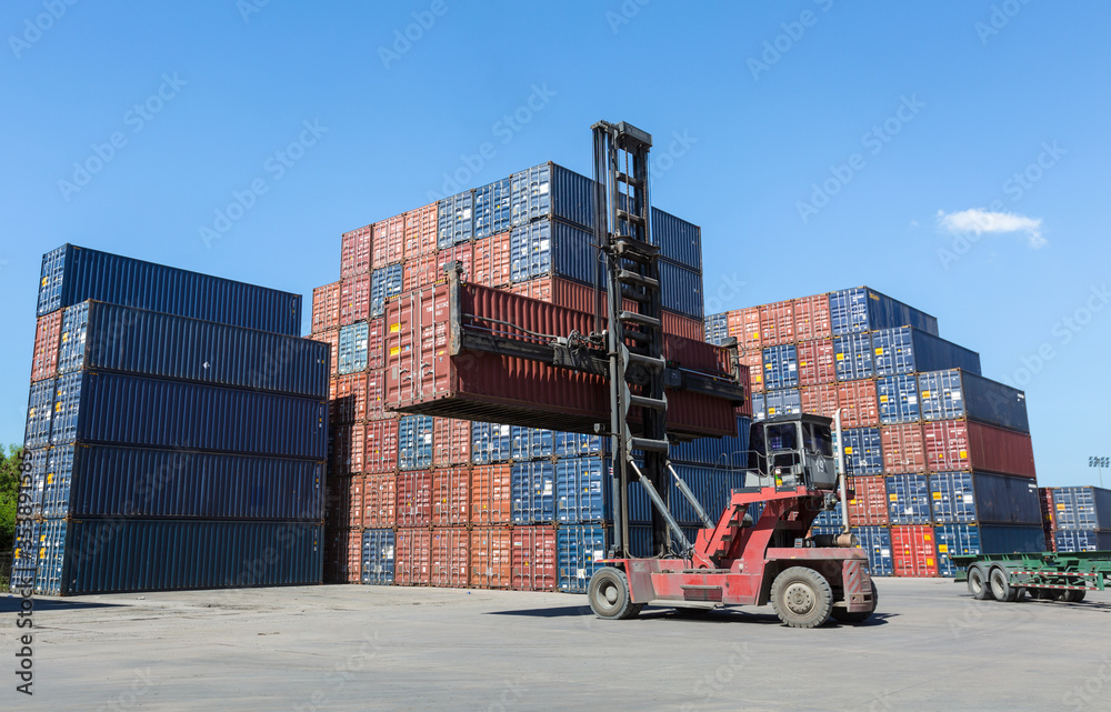 Lifting empty container to keep in container stack by reach stacker ...