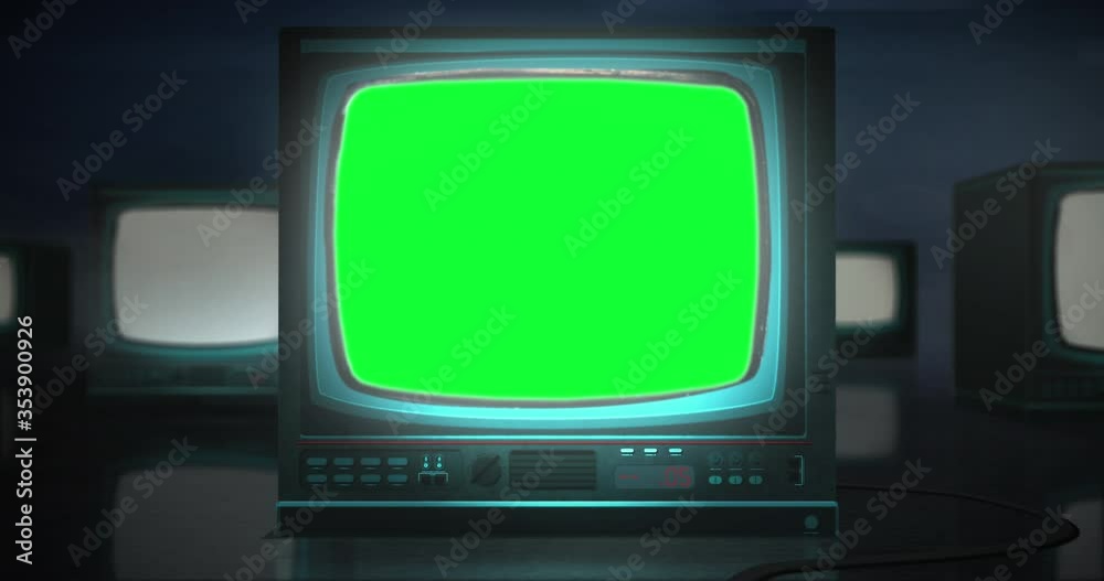 Green screen placeholder for video content on a screen in a dark room ...