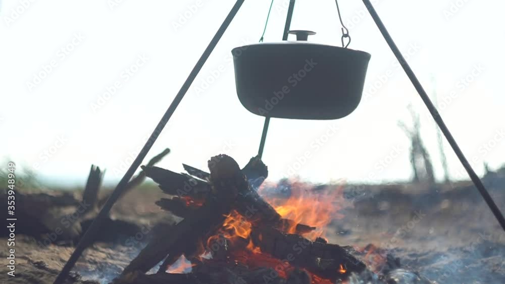 cauldron at the stake. camping in the wood. cooking on the fire. field ...