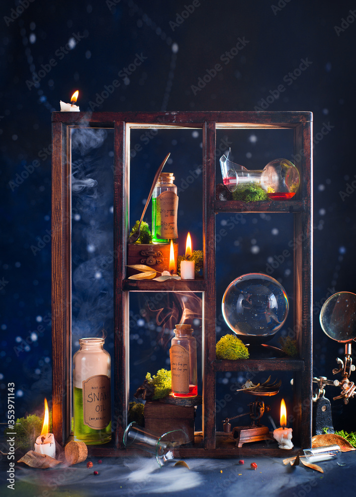 Witch workplace with potions, herbs and a crystal ball, magical still ...