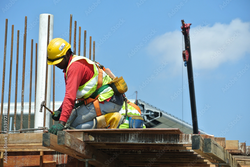 Construction workers fabricating timber form work mostly using timber ...
