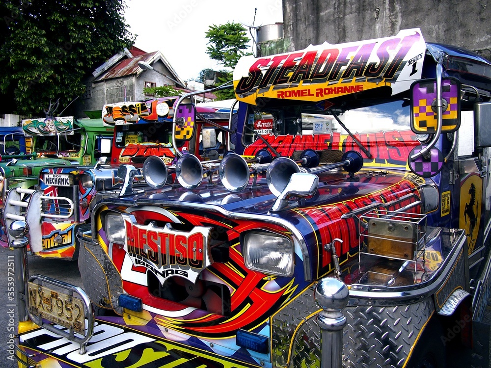 Colorful passenger jeepneys with artistic designs at a jeepney parking ...