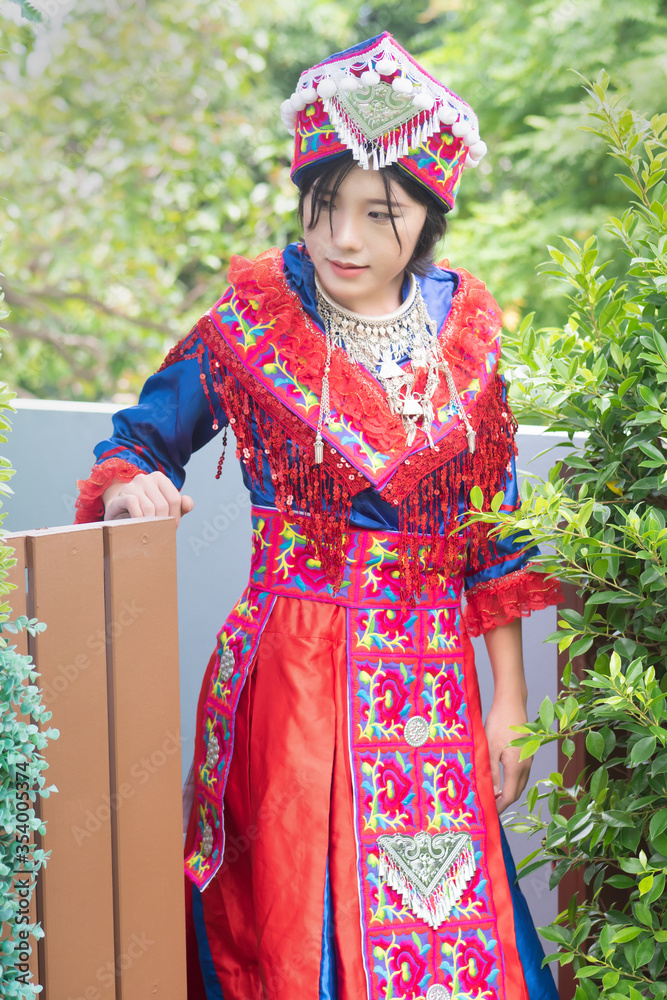 portrait of Hmong young woman looking up in tradition Hmong costume for ...