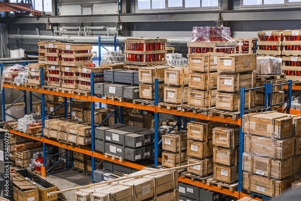 Warehouse with racks and shelves, filled with wooden boxes on pallets ...