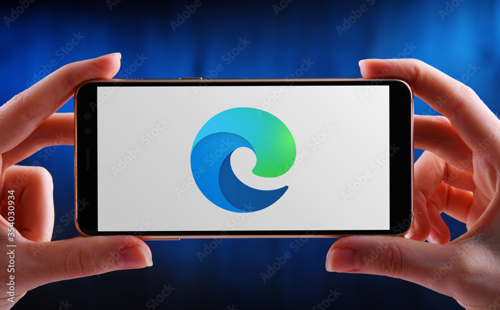 Hands holding smartphone displaying logo of Microsoft Edge Stock Photo ...