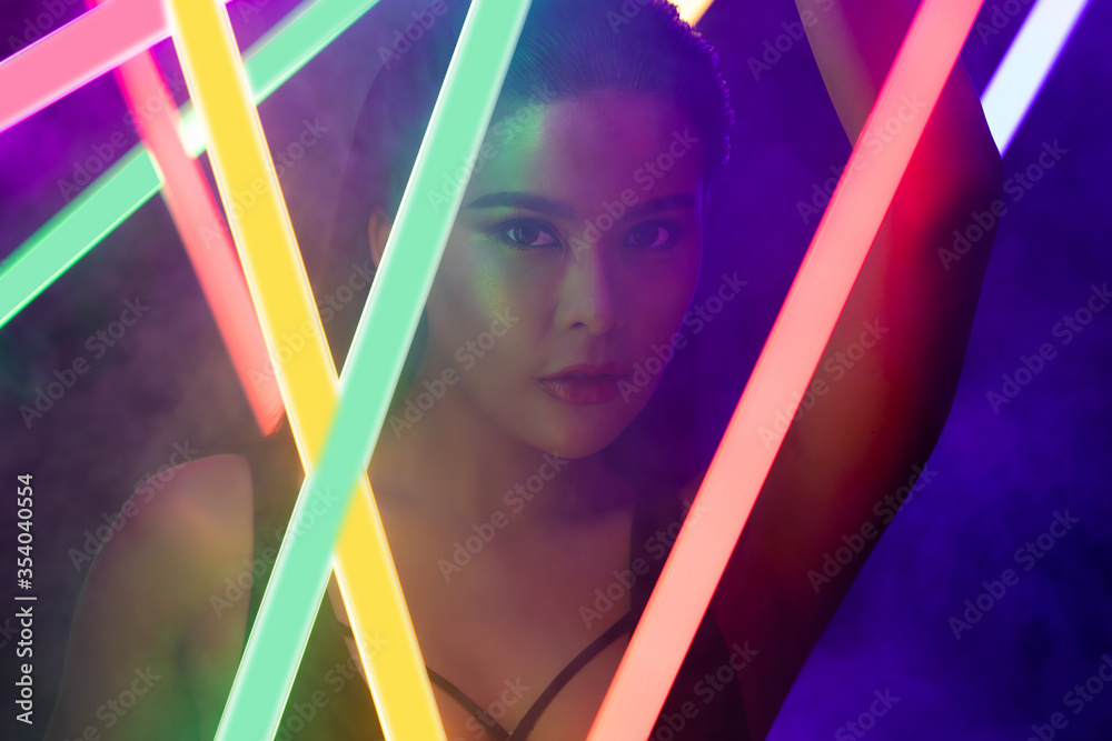 Face Close up of High Fashion Trend Cosmetic make up with NEON tube ...