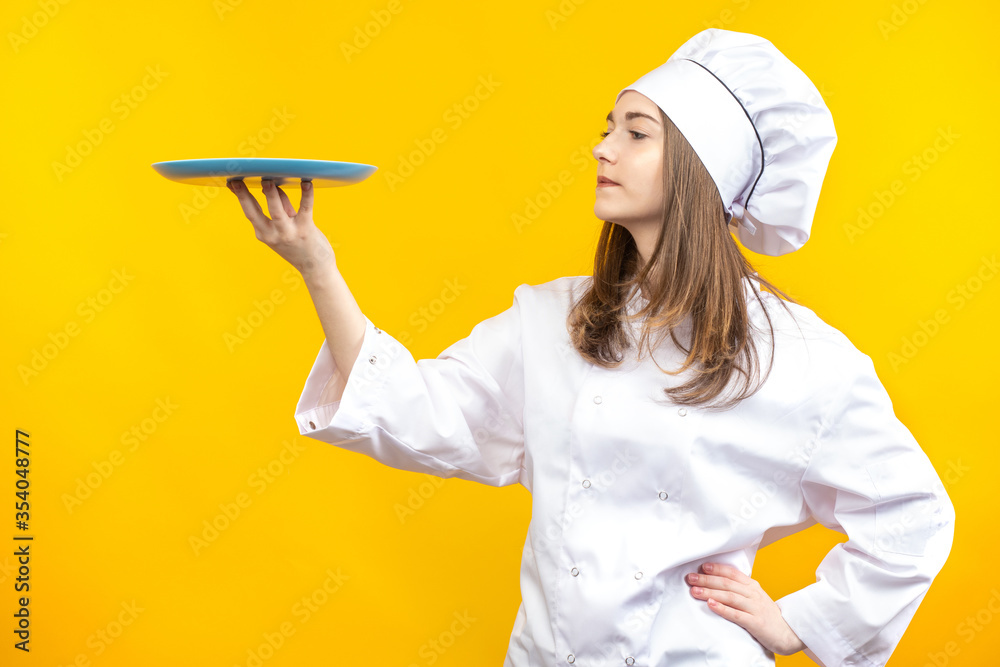 Cook girl. Cook is holding an empty plate. Empty plate in outstretched ...