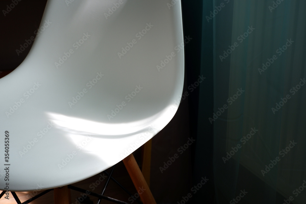 Beautiful stylish white chair. With rays of light. Interior. Minimalism ...