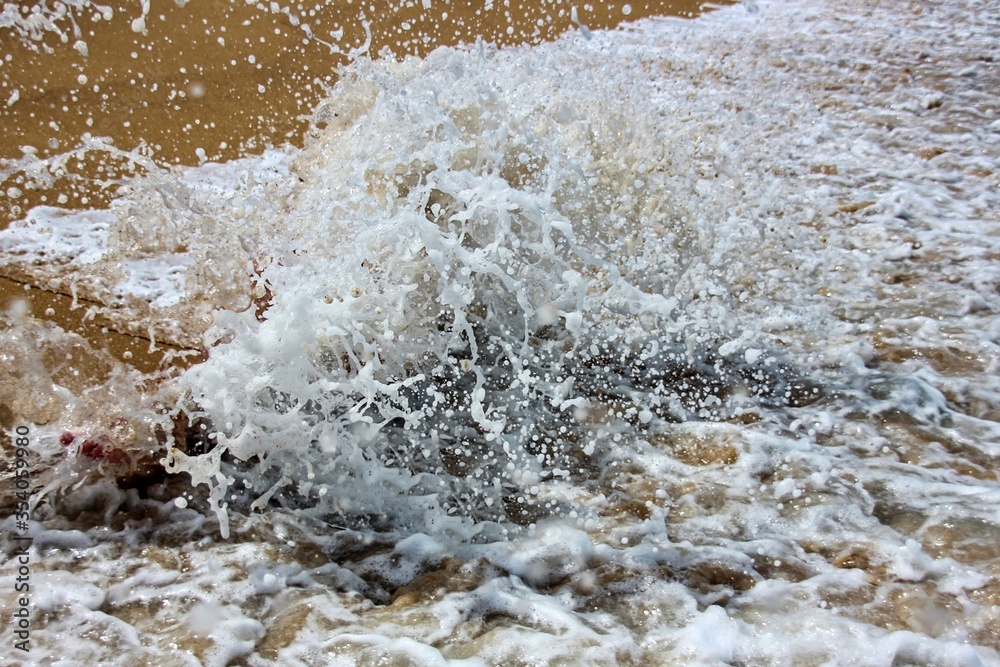 Beautiful white foamy water patterns on shallow sandy ocean beach. Sea ...