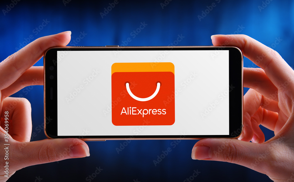 Hands holding smartphone displaying logo of AliExpress Stock Photo ...