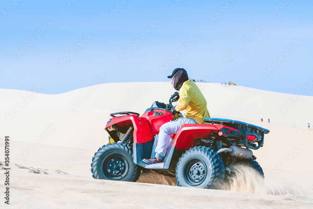 Tourist enjoy riding the quad bike or powerful fast off-road four-wheel ...