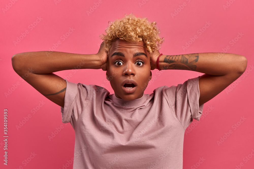 Shocked scared african american young student female clutching her head ...