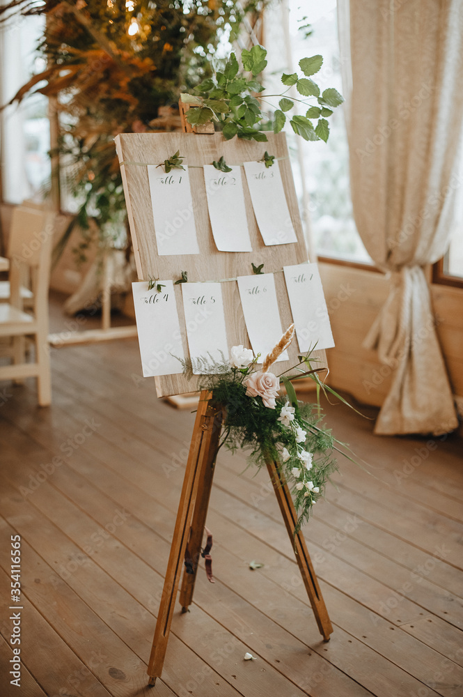 Seating plan, wooden board on an easel, paper cards with table numbers ...