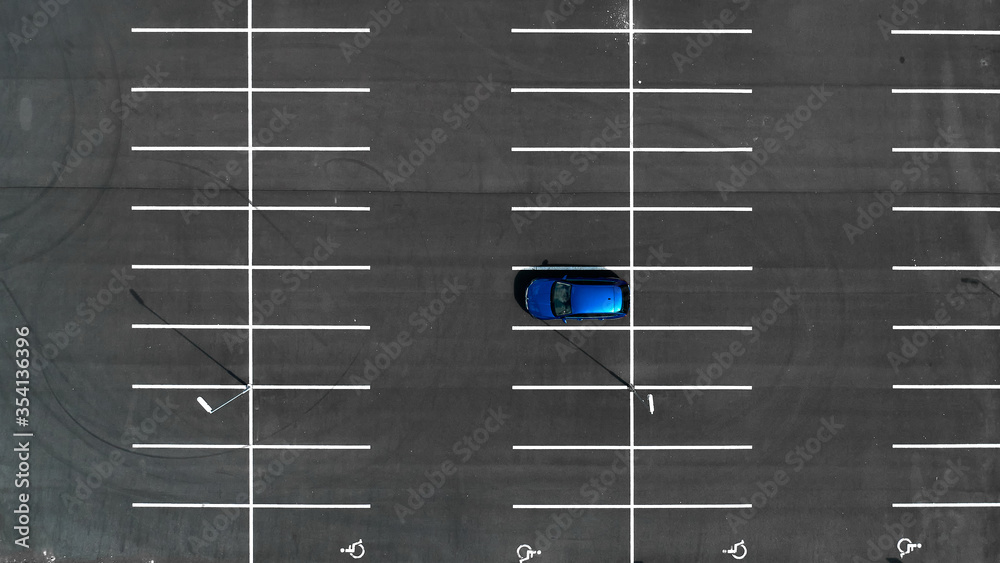 Top view on an empty parking lots with one blue car. Aerial view of car ...