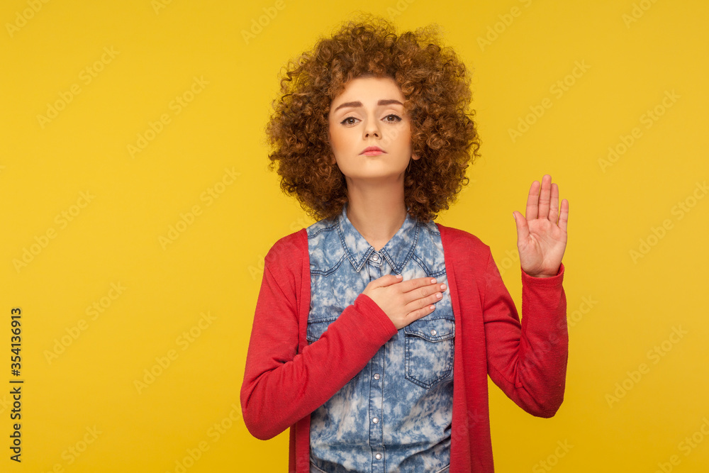 Promise to tell truth! Portrait of woman with curly hair raising hand ...